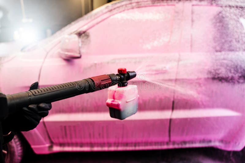 The Process of Applying Pink Foam To the Body of the Car Using a Foam ...