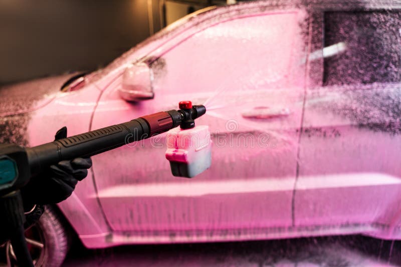 The Process of Applying Pink Foam To the Body of the Car Using a Foam ...