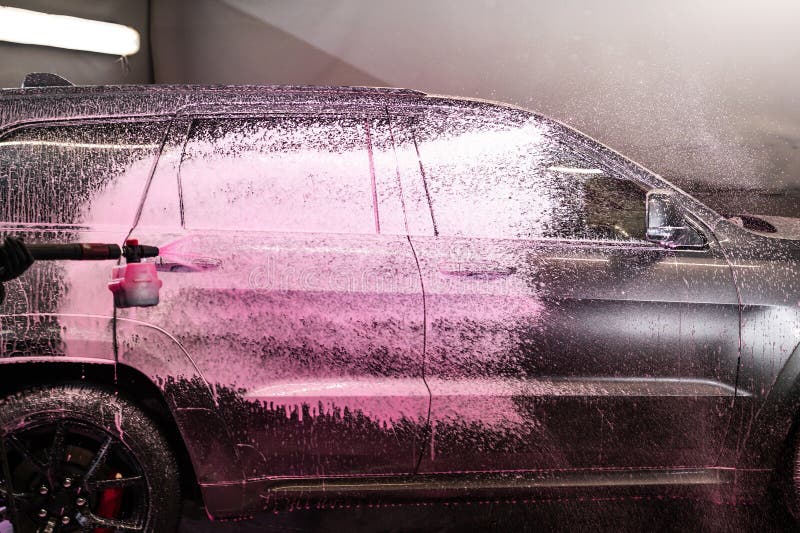 The Process of Applying Pink Foam To the Body of the Car Using a Foam ...