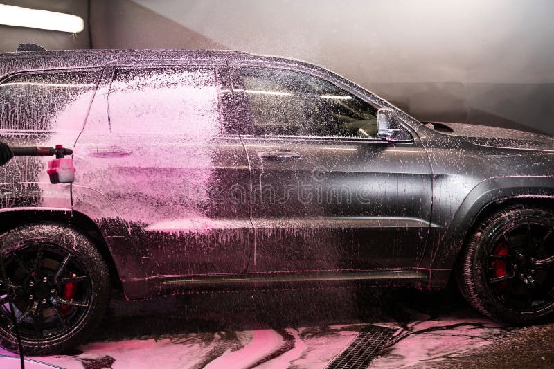 The Process of Applying Pink Foam To the Body of the Car Using a Foam ...