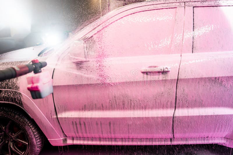 The Process of Applying Pink Foam To the Body of the Car Using a Foam ...