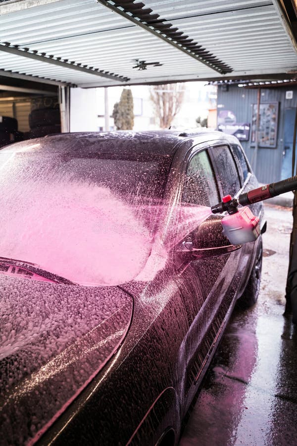 Process of Applying Pink Foam To the Windshield of the Car Using a Foam ...