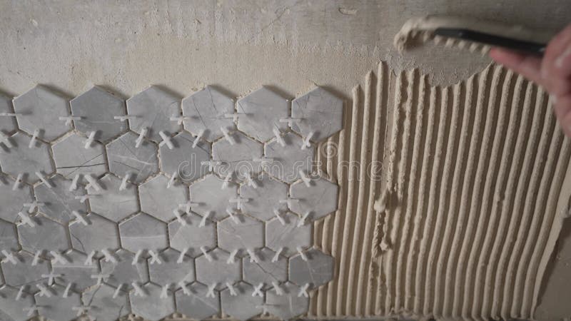 The Tile is Applying Adhesive To the Kitchen Wall. the Process of ...