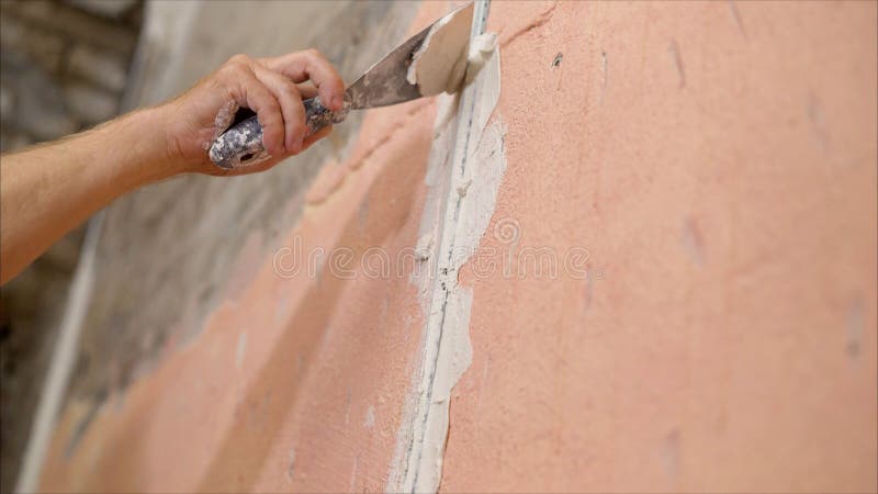 Applying Plaster Using a Spatula, Close-up. the Process of Applying ...