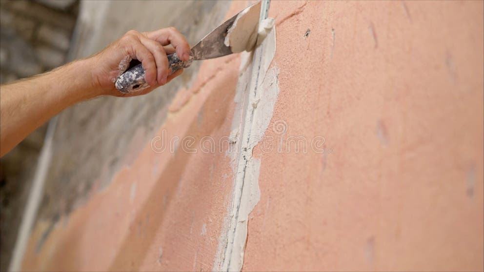 Applying Plaster Using a Spatula, Close-up. the Process of Applying ...