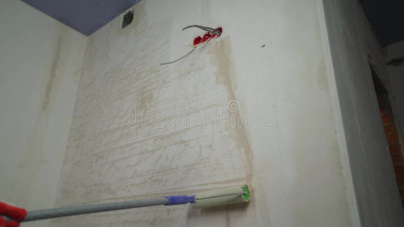 The Process of Applying a Primer To a Wall Using a Roller. the Primer ...