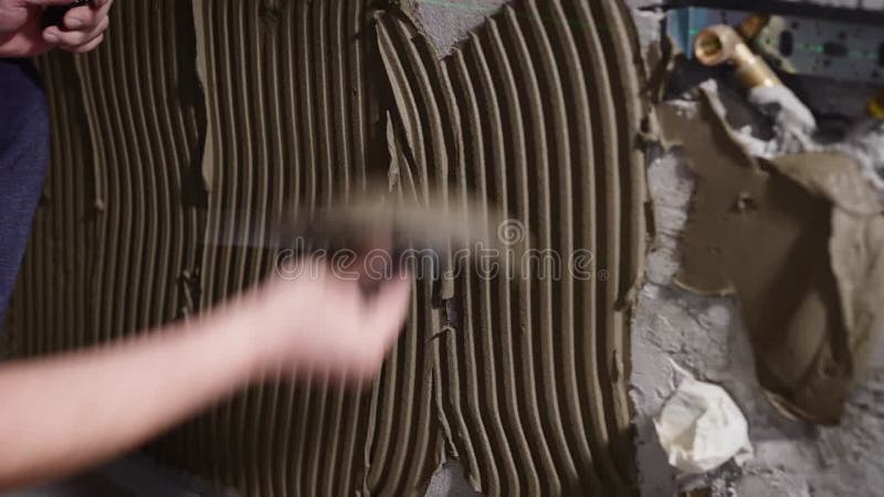 The Process of Applying Tile Adhesive To the Wall. Surface Preparation ...