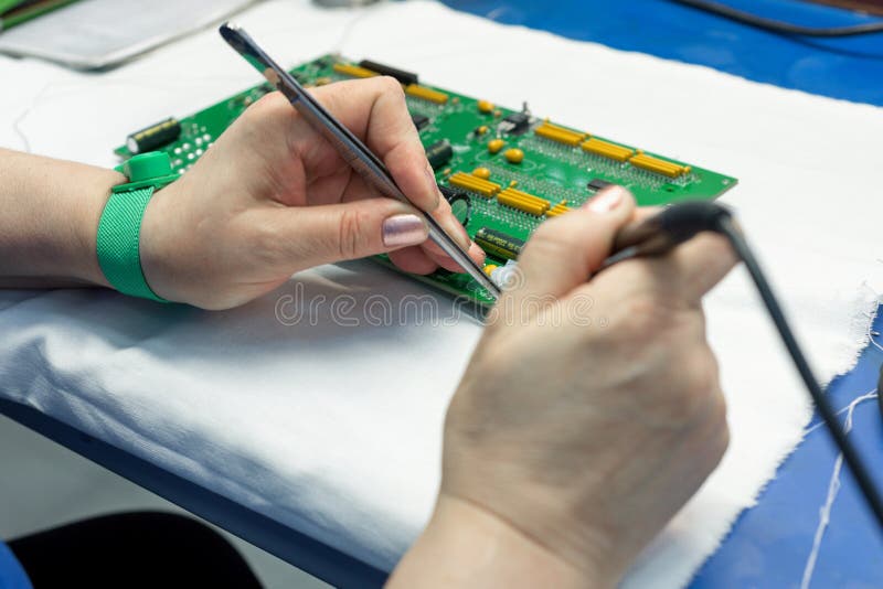 The Process of Assembling an Electronic Module. the Worker`s Hands ...