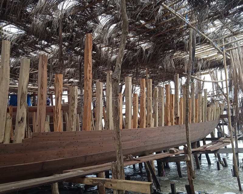 The Process of Assembling a Phinisi Ship with a Dry Coconut Leaf Roof ...