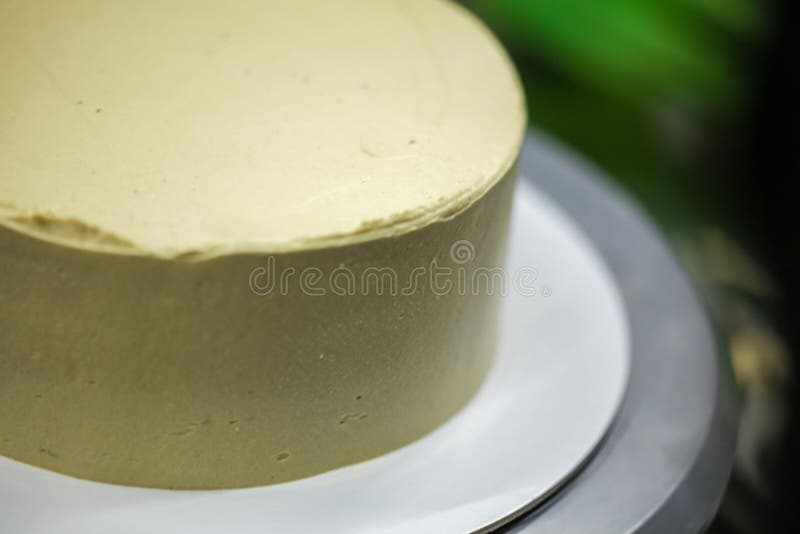 Process of Baking with Pastry Chef Smoothing the Pistachio Buttercream ...