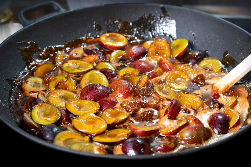 The Process of Boiling Plum Jam in a Cast Iron Pan Stock Photo - Image ...