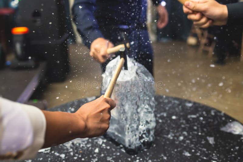 Process of Breaking the Ice with Hammer and Ice Pick, Group of People ...