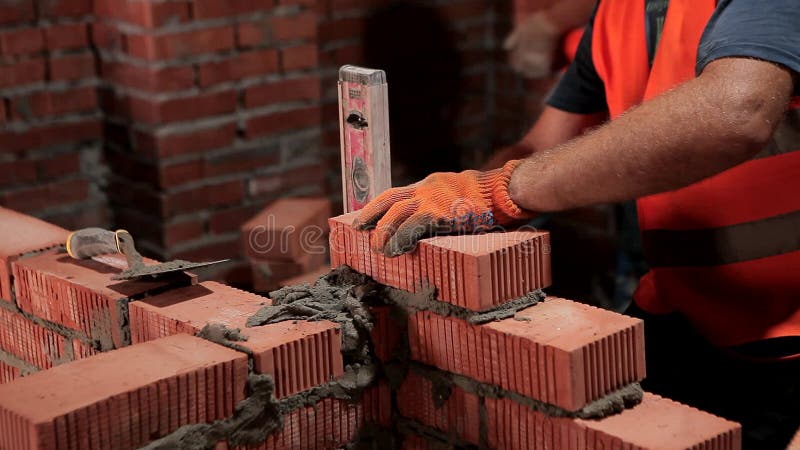 The Process of Building a Brick Wall. the Builder is Laying the Bricks ...