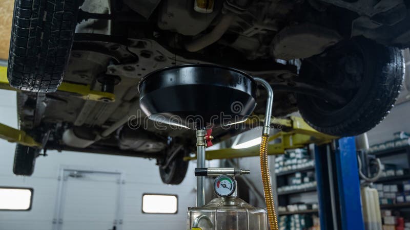 The Process of Changing the Oil in a Car Engine. Draining Old Dark Used ...