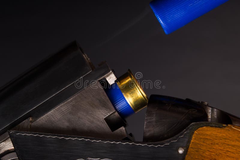 Process of Charging a Sports Gun for Shooting on a Black Background ...