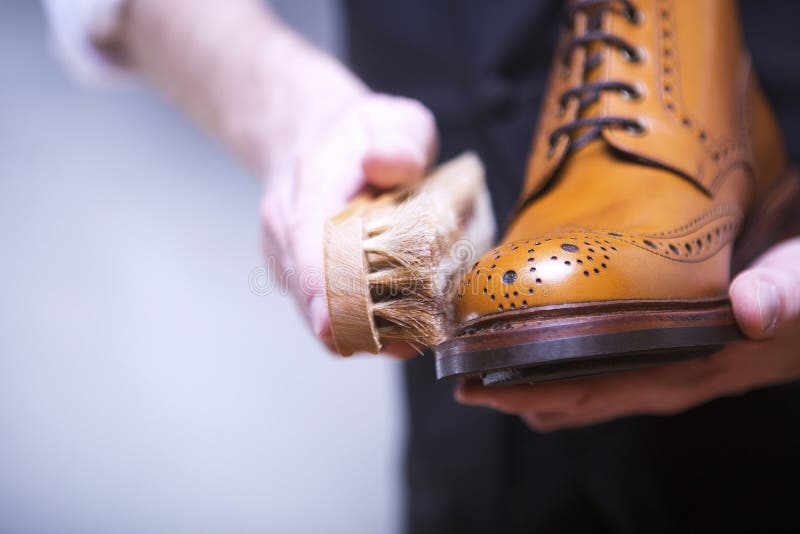 The Process of Cleaning Shoes. a Man is Cleaning His Shoes Stock Image ...