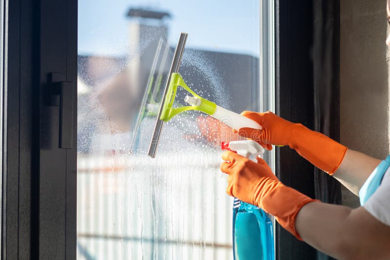 The Process of Cleaning Windows with Special Squeegee and Cleaner Stock ...