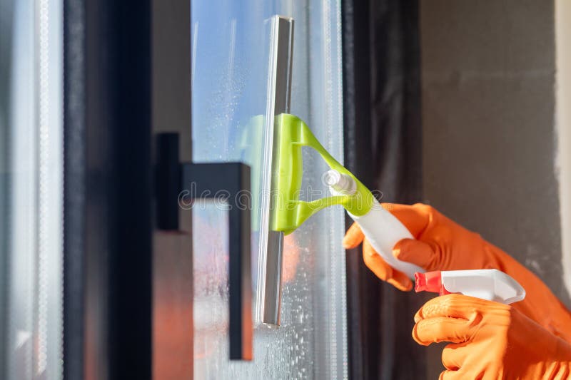 The Process of Cleaning Windows with Special Squeegee and Cleaner Stock ...