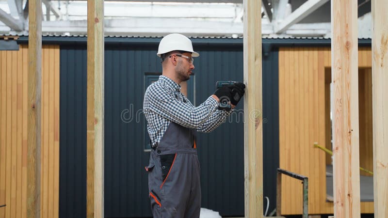 Worker Using Drill and Working on Building Development of Prefabricated ...
