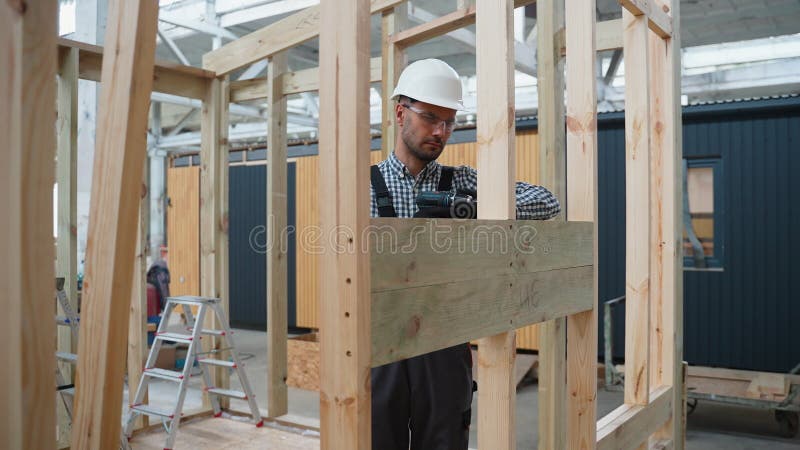 Worker Using Drill and Working on Building Development of Prefabricated ...