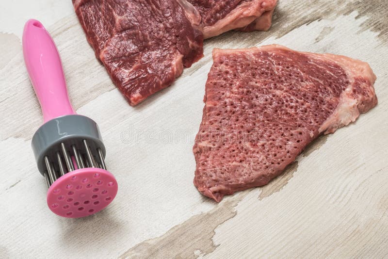 The Process of Cooking Beef Chops and a Special Device on a Wooden ...