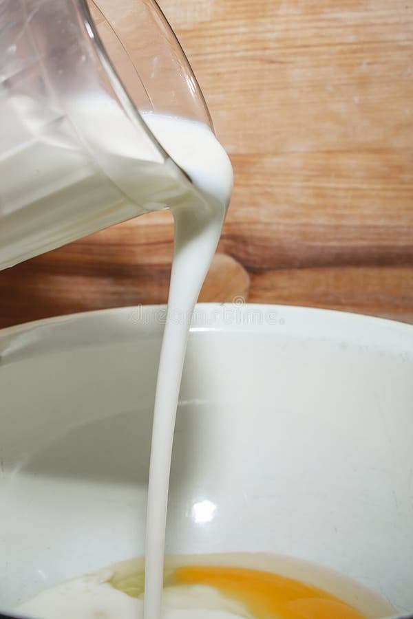 The Process of Cooking. the Cook Pours Milk into the Dough Stock Image ...
