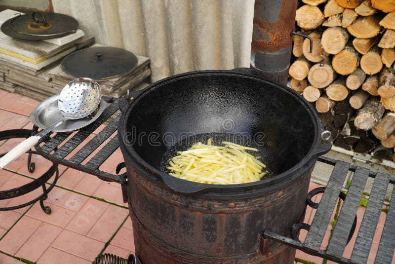 The Process of Cooking French Fries on a Fire in a Cauldron. Time for a ...