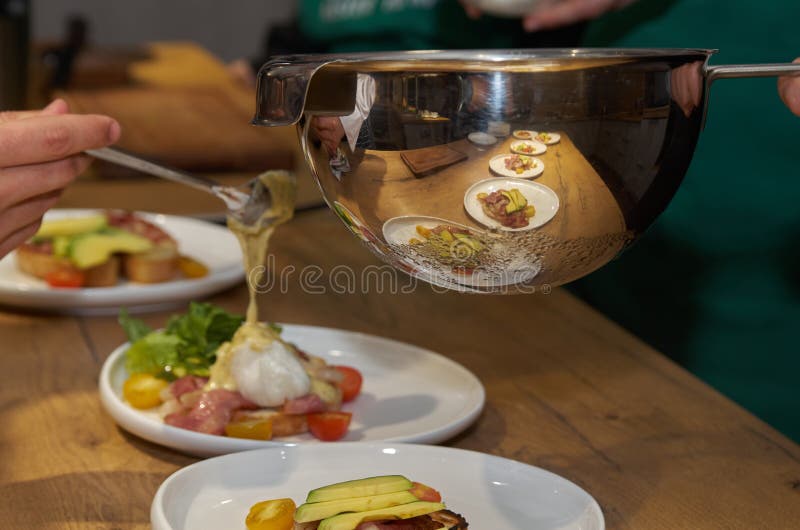 The Process of Cooking: Laying Out the Finished Dish on Plates Stock ...