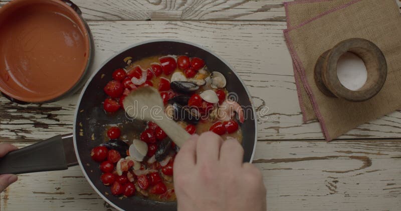 Process of Cooking Mix of Seafood and Tomato Sauce on the Cooking Pan ...