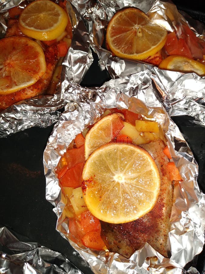 The Process of Cooking Red Trout Fish with Lemon and Vegetables in Foil ...