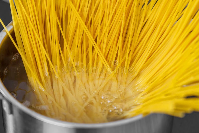 The Process of Cooking Spaghetti in a Pan on the Stove Stock Photo ...