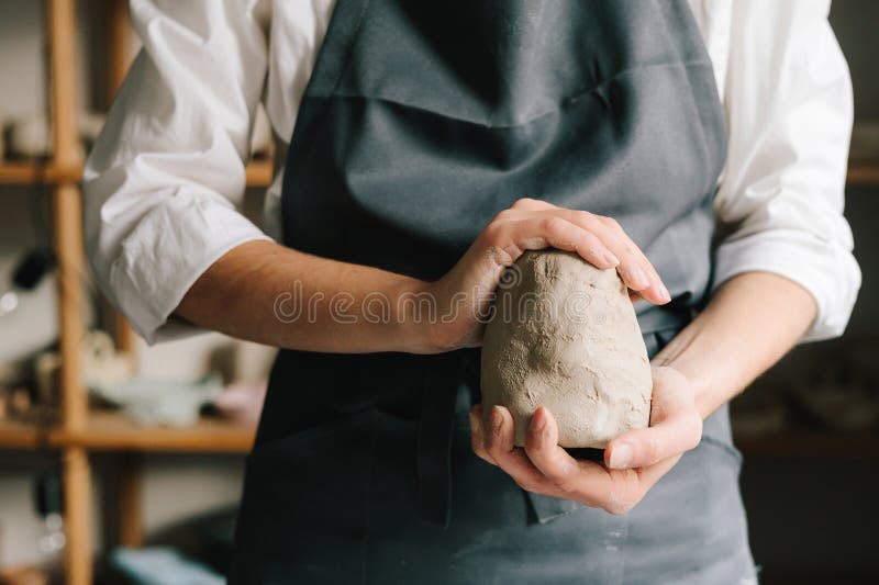 Process of Creating Ceramic Products. Potter Holds a Piece of Wet Clay ...