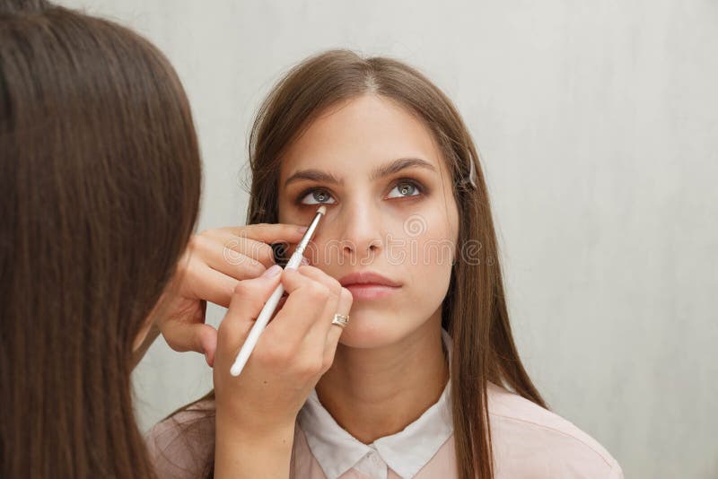 The Process of Creating Makeup. Makeup Artist Working with a Brush on ...