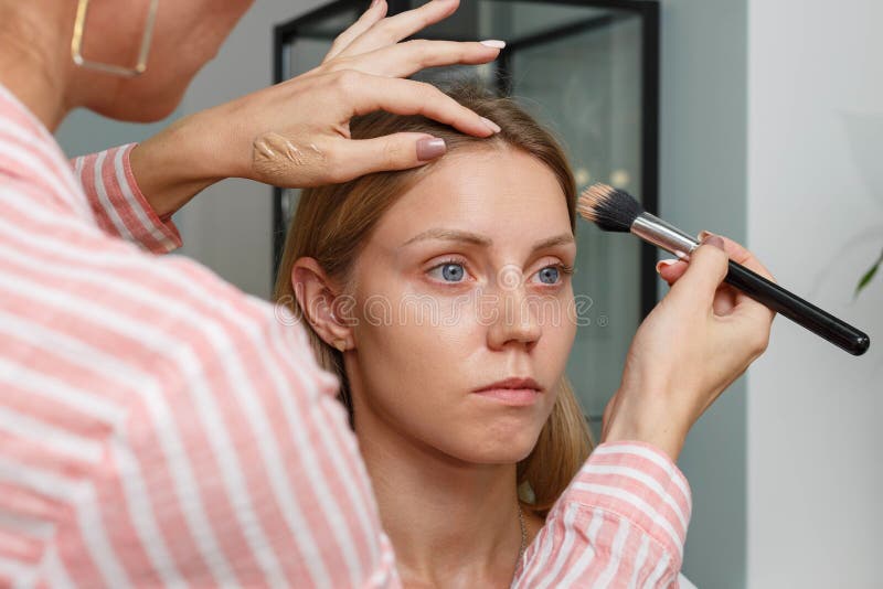 The Process of Creating Makeup. Makeup Artist Working with a Brush on ...