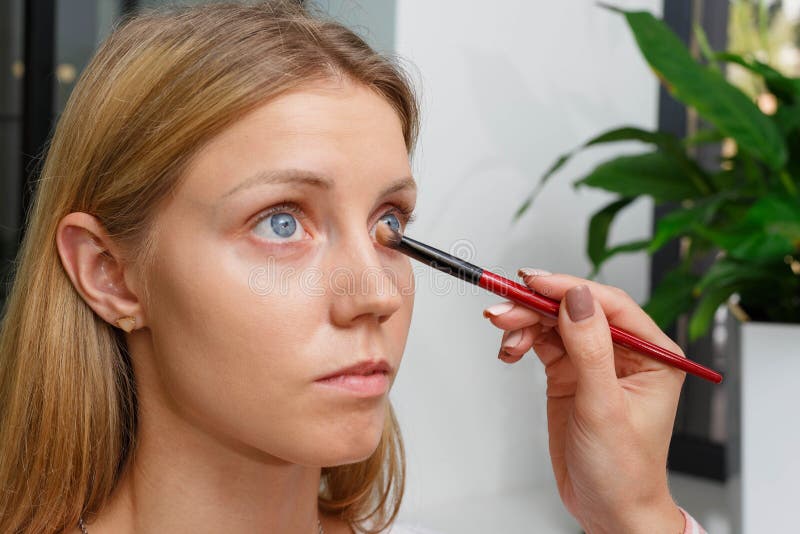 The Process of Creating Makeup. Makeup Artist Working with a Brush on ...