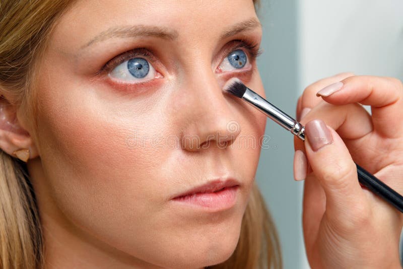 The Process of Creating Makeup. Makeup Artist Working with a Brush on ...