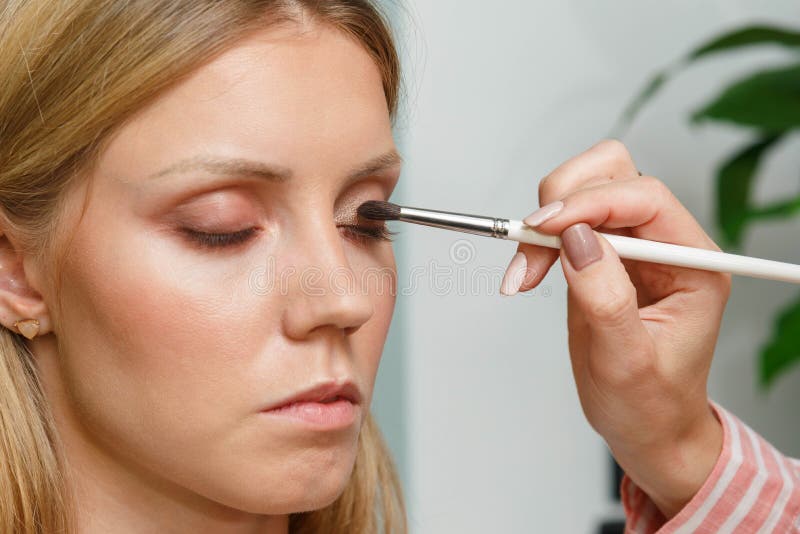 The Process of Creating Makeup. Makeup Artist Working with a Brush on ...