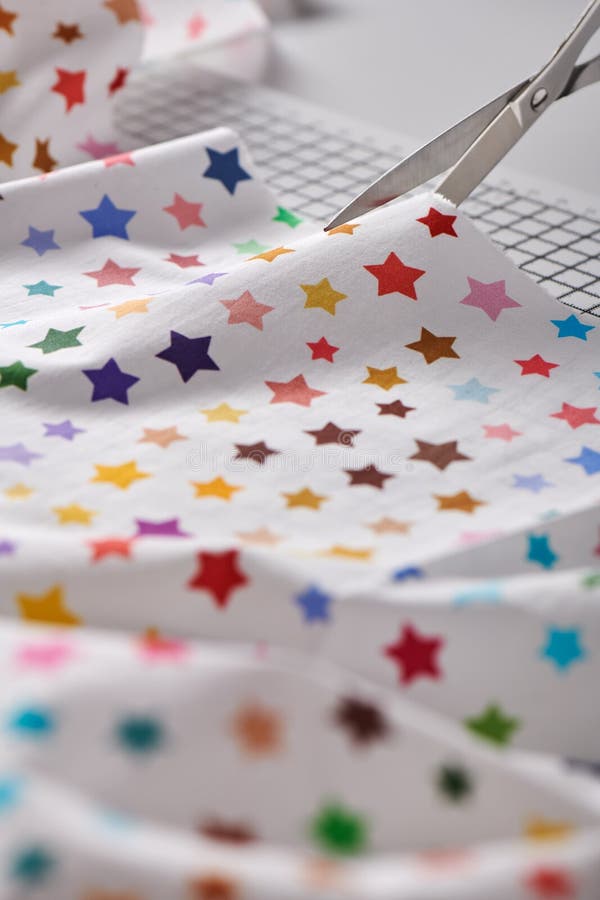 Process Cutting Fabric with a Pattern of Colorful Stars by Scissors on ...