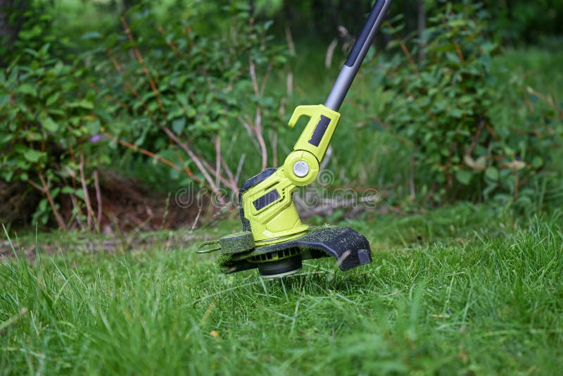 Process of Cutting Grass with a Professional Grass Trimmer Stock Photo ...