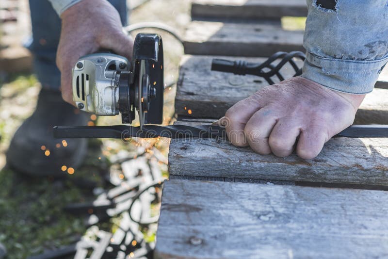 The Process of Cutting Metal Using the Angle Grinder Stock Photo ...
