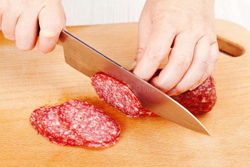 The Process of Cutting Salami Stock Photo - Image of sausage, wood ...