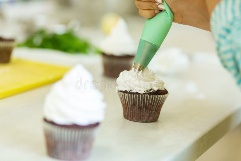 The Process of Decorating Chocolate Cupcakes with Airy Protein Cream ...