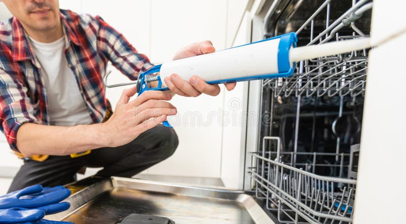 Process of Dishwashing Machine Installation. Young African Service Man ...