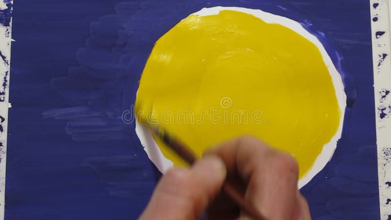 The Process of Drawing a Yellow Sun or Moon on a Blue Background with ...
