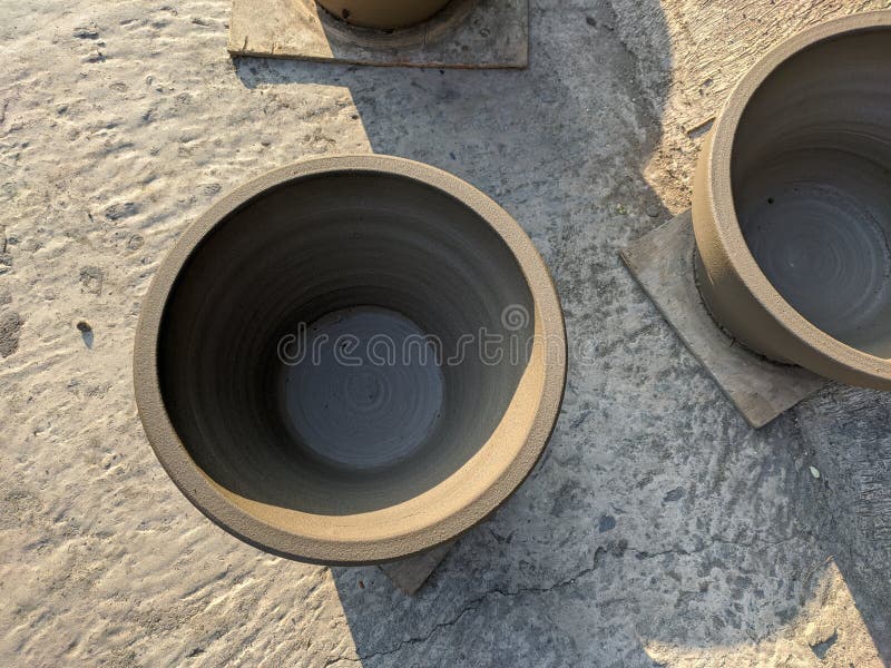 The Process of Forming a Round Shaped Pottery Base for Cooking Made of ...