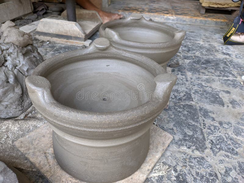 The Process of Forming a Round Shaped Pottery Base for Cooking Made of ...