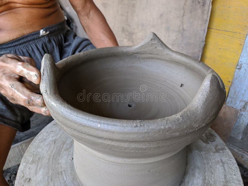 The Process of Forming a Round Shaped Pottery Base for Cooking Made of ...