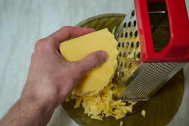 Grated Cheese on Red Grater in Kitchen Bowl Stock Image - Image of ...