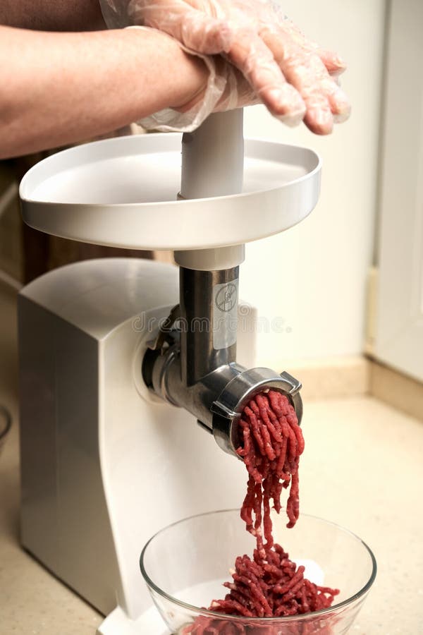 The Process of Grinding Meat into Minced Meat in a Meat Grinder. Gloved ...