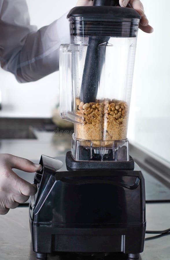 The Process of Grinding Peanuts in a Blender in the Kitchen Stock Image ...
